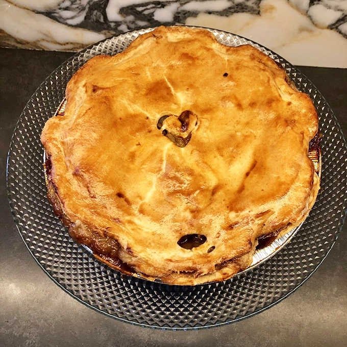 A whole apple pie with that perfectly golden crust that would make your grandmother nod approvingly from across the room.