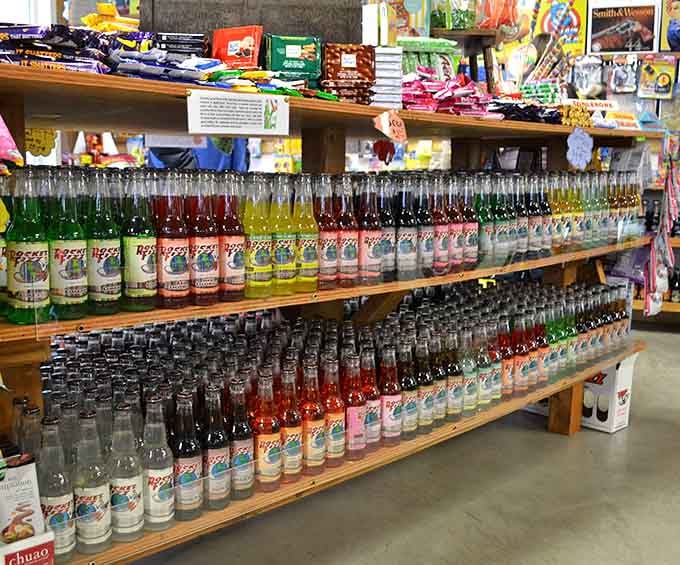 Shelves overflow with glass bottles in every hue, proving that soda shopping is serious business.