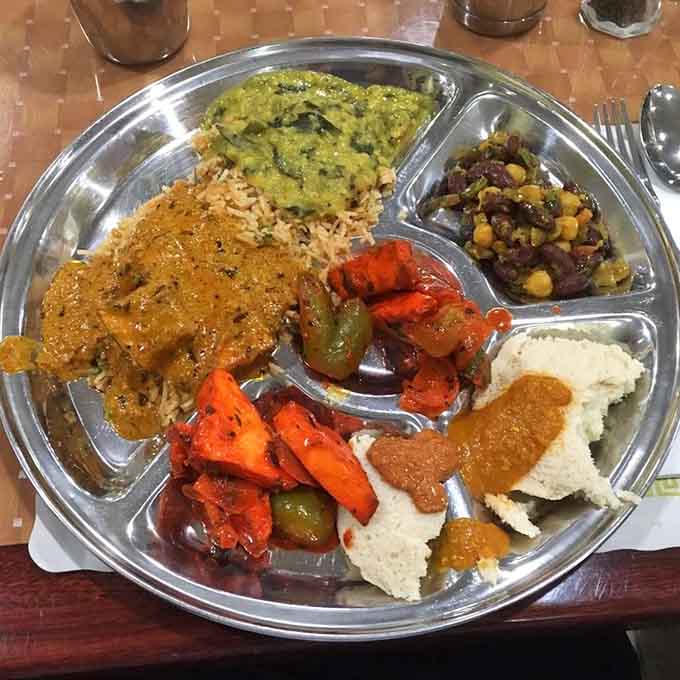 A compartmentalized plate of pure joy where every section holds a different flavor adventure waiting to happen.