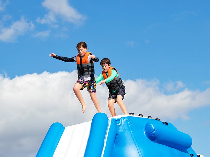 Pure joy captured mid-slide as these kids demonstrate the universal appeal of launching yourself into refreshing water.
