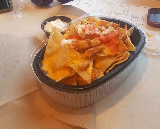 Nachos piled high with all the fixings, because sometimes you need a mountain of cheese happiness.