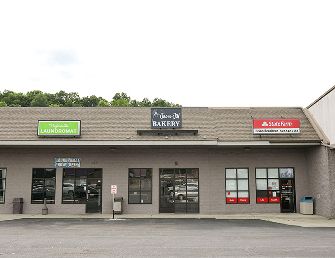 The local bakery sits quietly in this strip, ready to sweeten your day with fresh-baked treats.