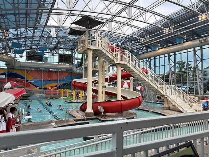Red slides twisting through the air while kids splash below: organized chaos at its finest and most fun.