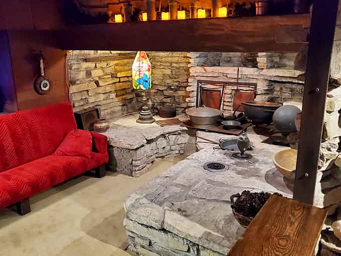 Stone walls and vintage cookware create a cozy hearth that looks straight out of a medieval fantasy novel.