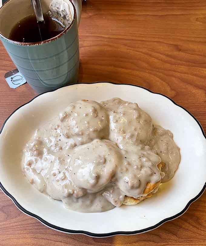 Four fluffy biscuits drowning in sausage gravy, because subtlety has no place at breakfast time.