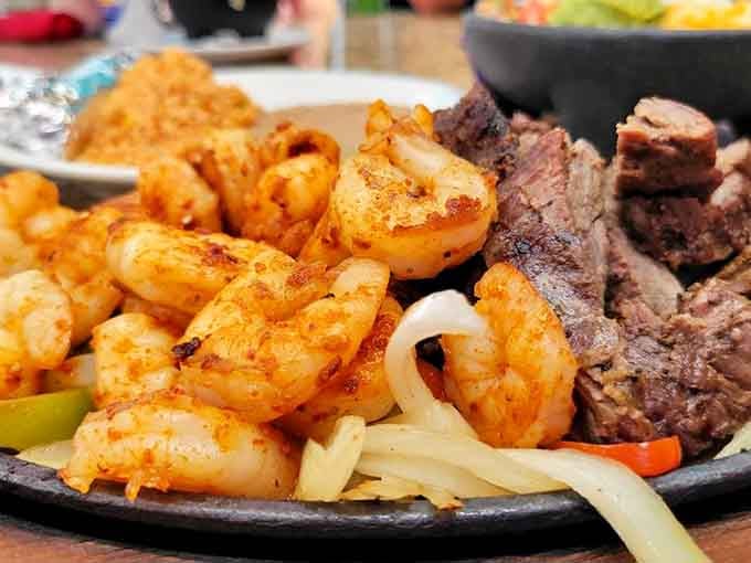 Smoky, spiced shrimp and grilled beef on one sizzling platter, because why choose when you can have both?