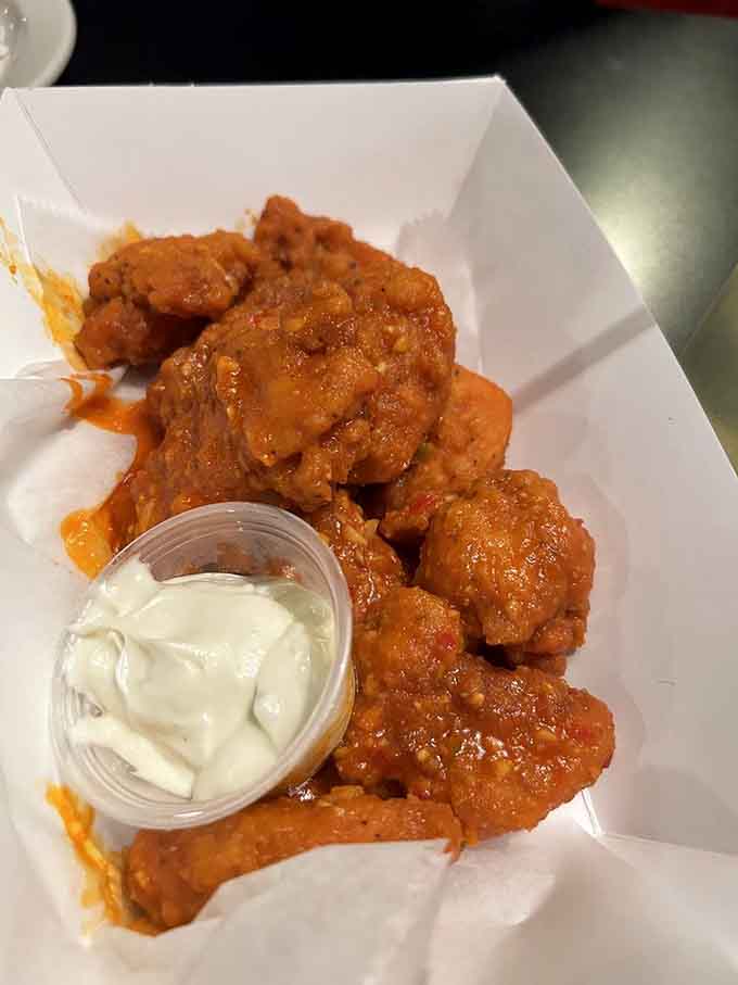 These wings come glazed in sauce so good you'll forget you're dining beneath decorations that celebrate the great beyond.