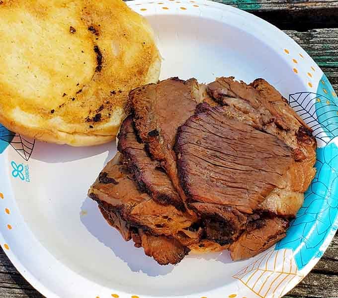Brisket sliced thick enough to appreciate every hour it spent in that smoker, nestled on a perfectly toasted bun.