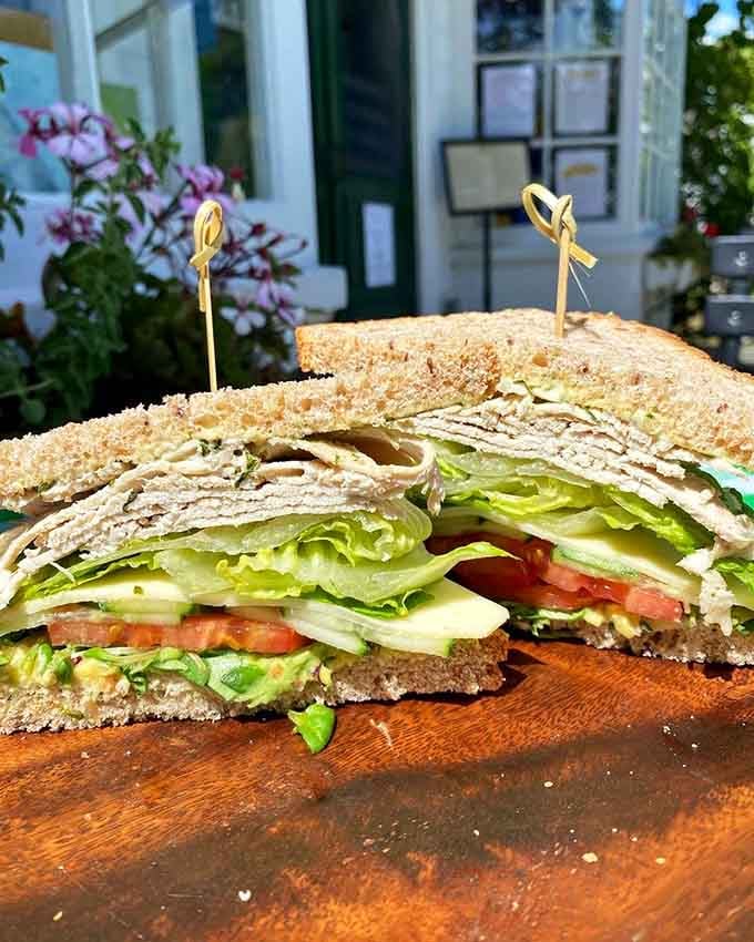 Stacked high and held together with hope, this sandwich showcases fresh ingredients that actually taste like they came from somewhere nearby.
