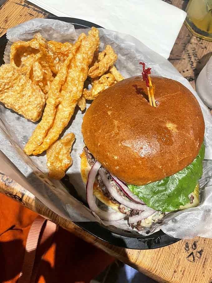 When your burger comes with a side of crispy pork rinds, you know you're in the right place.