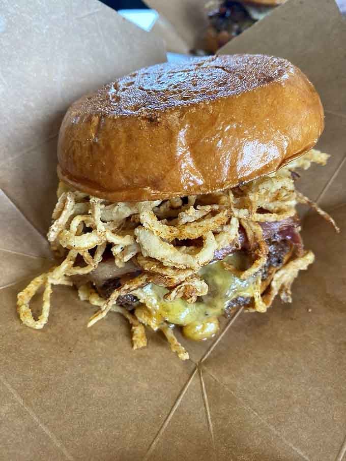 Crispy onion strings piled so high they're practically defying gravity, creating a crunchy crown fit for burger royalty.