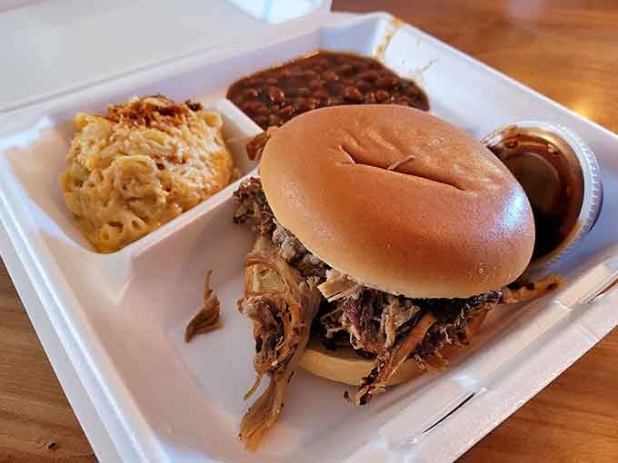 Pulled pork piled high on a soft bun, flanked by sides that could headline their own show.