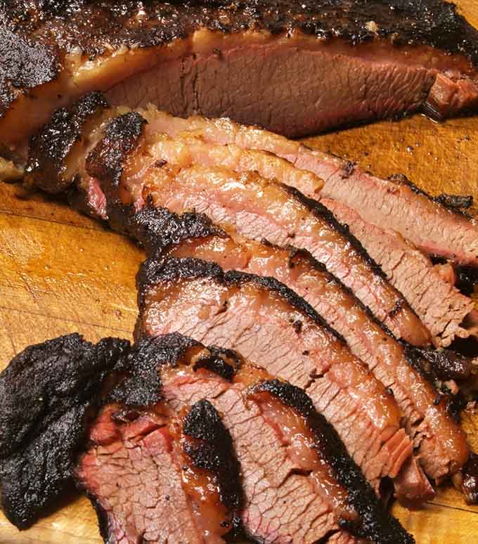 Sliced brisket revealing that perfect smoke ring &ndash; the kind of beauty that belongs in an art museum.