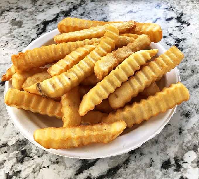 Crinkle-cut fries so perfectly golden they could win beauty pageants, if beauty pageants were delicious and edible.