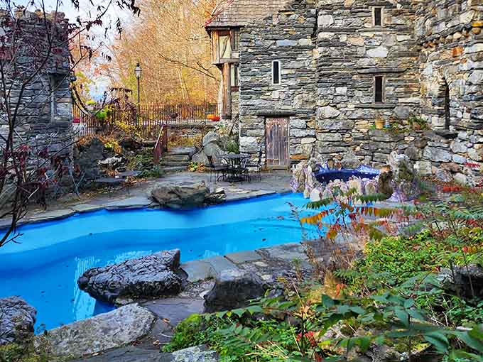That bright blue pool winding through stone courtyards might just be the most whimsical water feature you've ever seen.