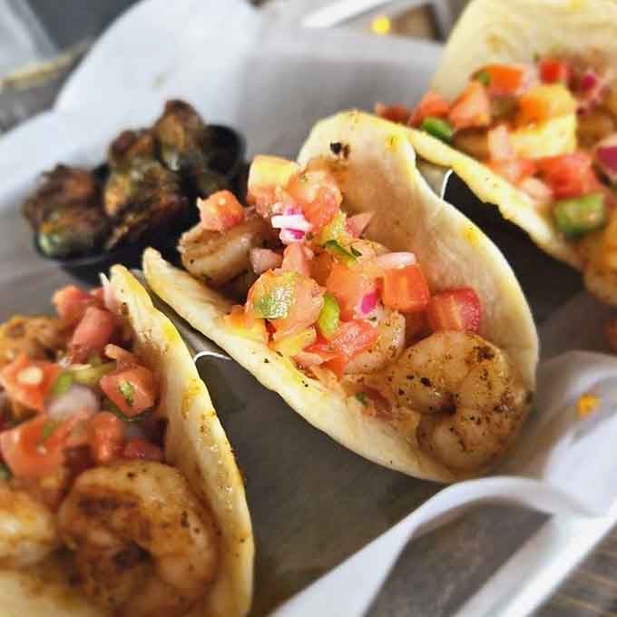 Shrimp tacos dressed up in crispy shells: proof that handheld food can be downright sophisticated.