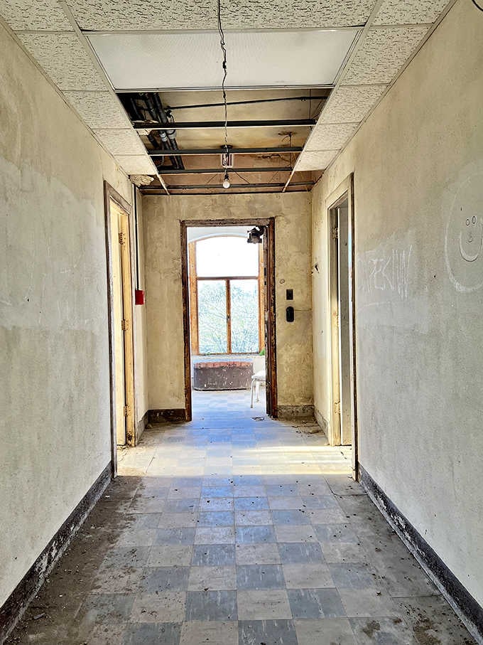 Corridors that once bustled with medical staff now echo with footsteps that shouldn't technically be there at all.