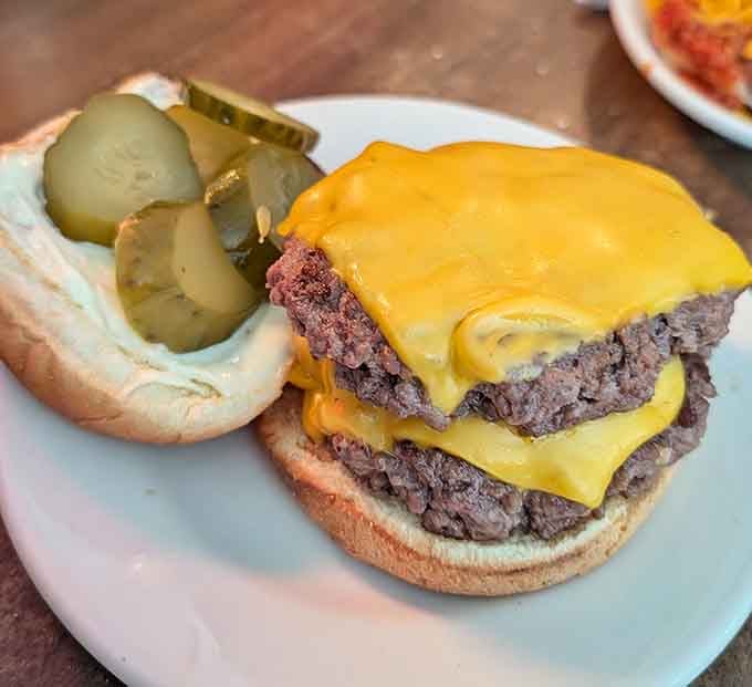 Two patties, melted cheese, and pickles create the kind of burger that haunts your dreams, deliciously.