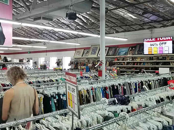 Fellow treasure hunters navigate the aisles with the focus of archaeologists, searching for that one perfect vintage find.