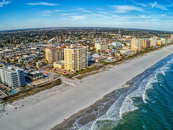 That endless stretch of sand meets a skyline that hasn't forgotten its small-town roots despite the towers.