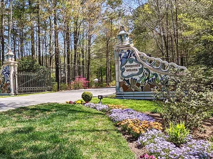 An artistic entrance sign welcomes visitors to gardens where sculpture and nature dance together in woodland settings.