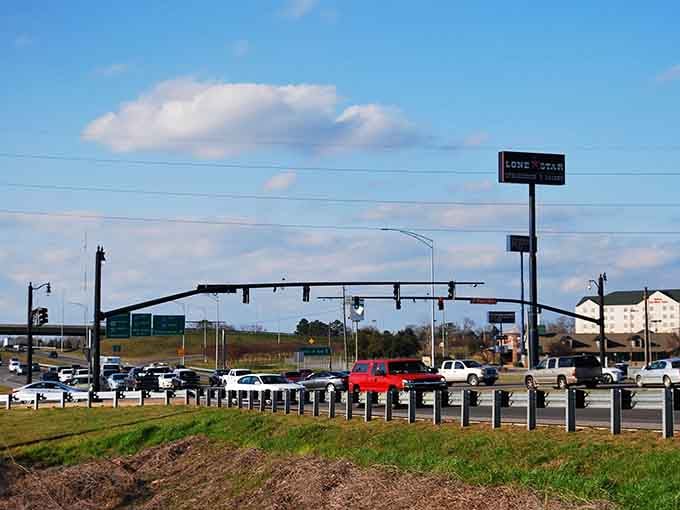 Modern life meets scenic byway where traffic lights stand guard over hills that have seen centuries pass by.