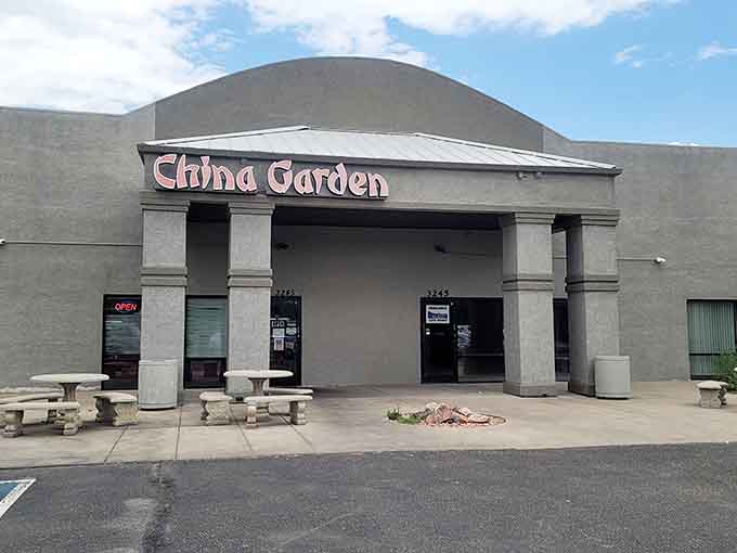 The classical columns frame an entrance to authentic flavors hiding in plain sight within this shopping center.