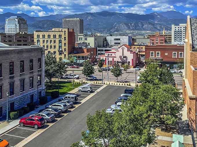 Historic buildings frame tree-lined streets where Pikes Peak stands guard like a patient sentinel over everyday life.