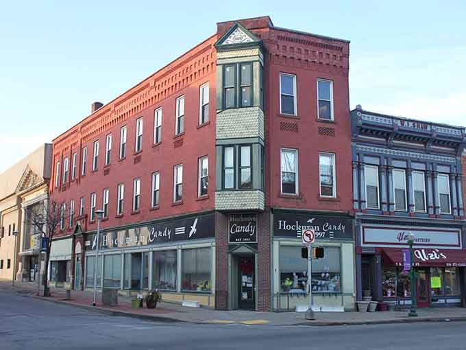 Classic storefronts with bay windows remind you why small-town architecture beats cookie-cutter chains every single time.