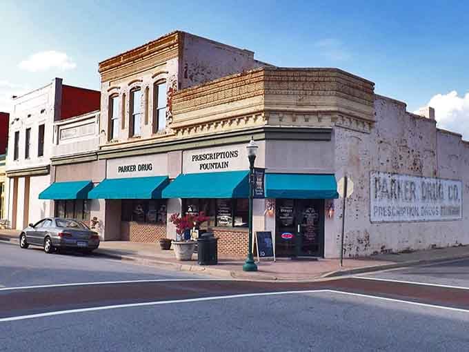 Ghost signs on brick walls whisper stories from decades past when this corner pharmacy served the whole community.