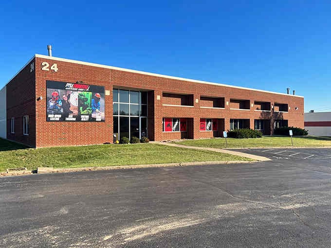 Classic brick building with colorful banners welcomes families seeking thrills without the pretense of fancy corporate entertainment complexes.