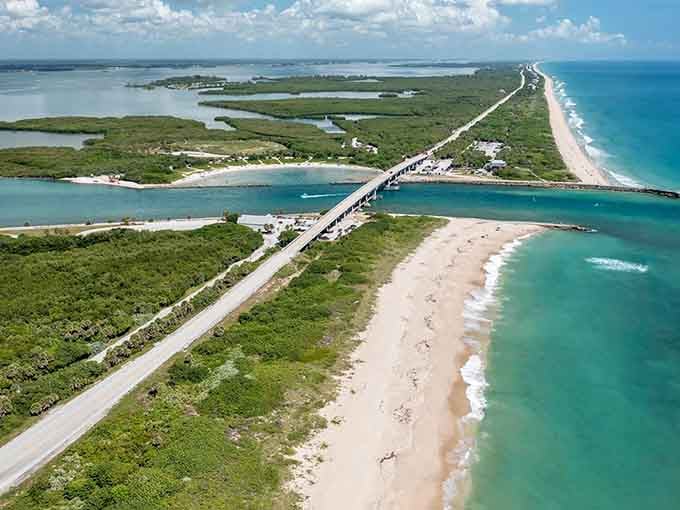 Turquoise ocean meets pristine white sand as the highway threads between beach and bay in perfect balance.