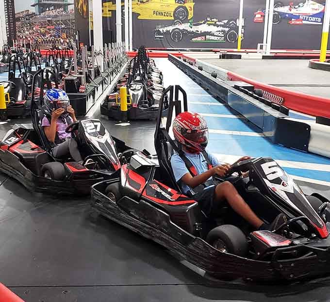 Racing imagery decorates the walls while sleek karts wait patiently for their next pilots in this polished facility.