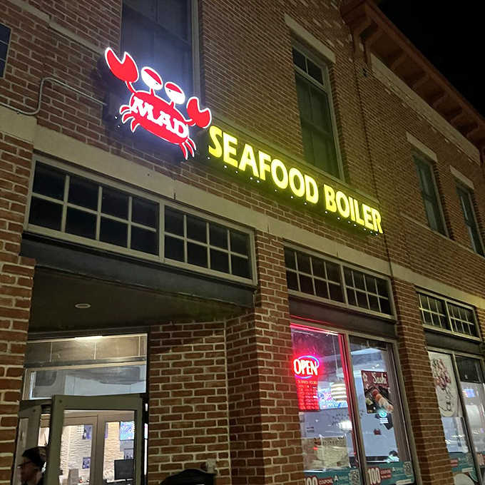 That glowing neon crab sign cuts through the darkness like a beacon for seafood lovers everywhere.