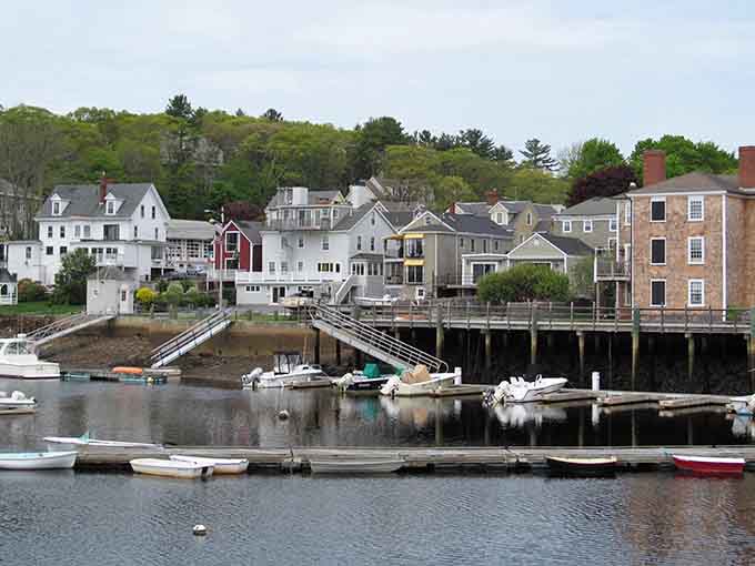 Colorful boats bob peacefully in the harbor while historic homes climb the hillside in perfect coastal harmony.