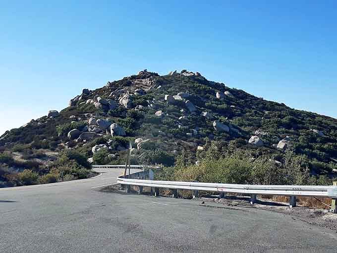 Boulder-strewn hillsides frame this desert road like nature's own rock garden, wild and wonderfully untamed.