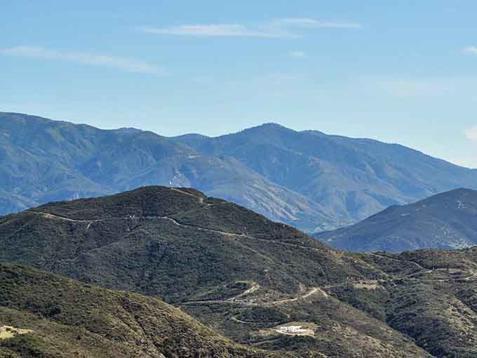 Mountain ridges fold into each other like accordion pleats, creating depth that photographs simply can't capture.
