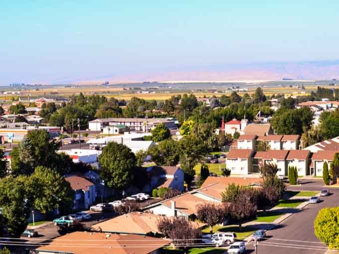 Neat residential neighborhoods stretch toward farmland where the air smells clean and your nearest traffic jam involves a tractor.