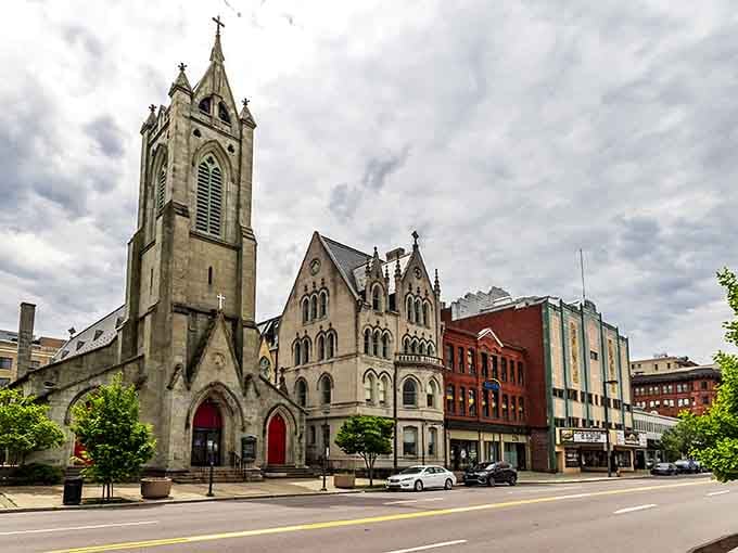 Gothic spires pierce the skyline, reminding you that faith and community built these coal country streets together.