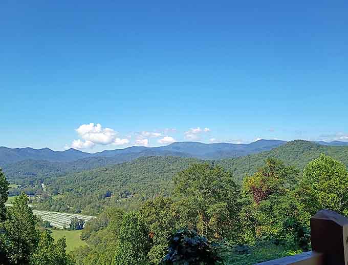 Layers of mountains fade into soft blue haze, creating depth that makes your eyes keep searching for more.