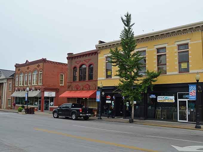 Red awnings pop against butter-yellow facades in a color combination that just works, no questions asked.