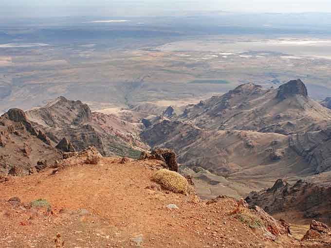 From Steens Mountain's rocky summit, the high desert spreads below like a rumpled blanket of earth tones.