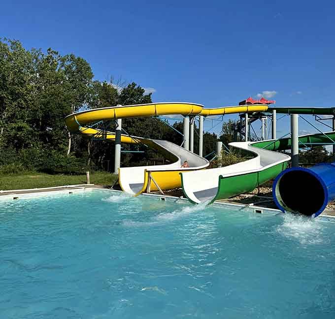 Multiple slides converge at this sparkling pool like colorful highways all leading to the same refreshing destination below.