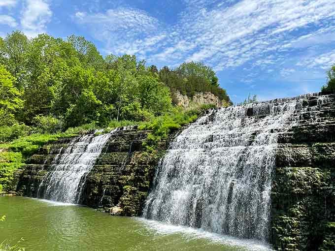 Thunder Bay's wide cascade spreads across layered rock ledges, creating multiple streams that shimmer in the sunlight.