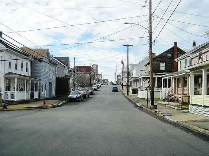 Quiet residential streets stretch toward the horizon with modest homes lining both sides, embodying small-town simplicity at its most genuine.