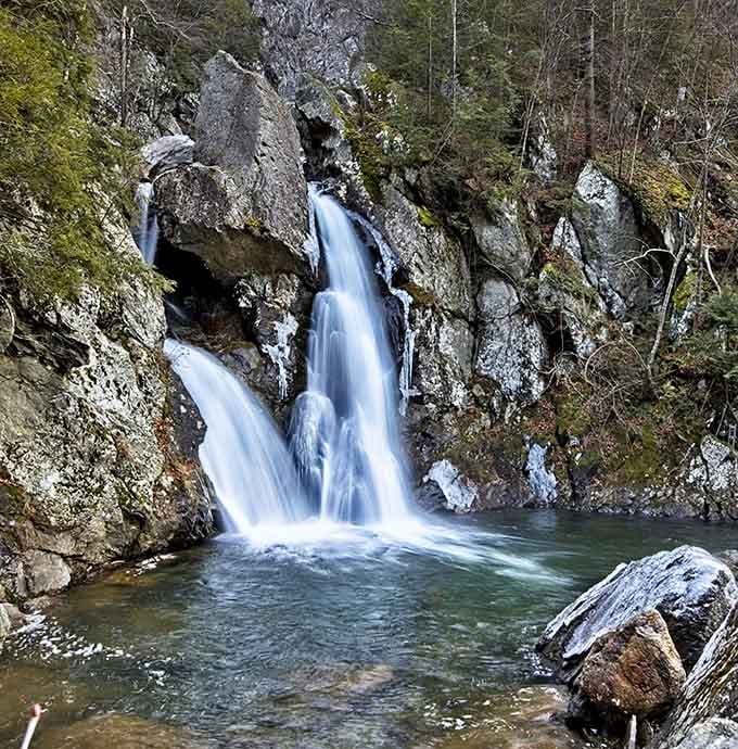 Ice clings to the waterfall's edges while water continues its eternal dance downward, creating a winter sculpture that changes daily.