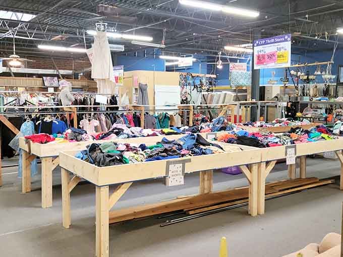 Colorful clothing mountains rise from display tables like fabric rainbows waiting to brighten someone's wardrobe today.