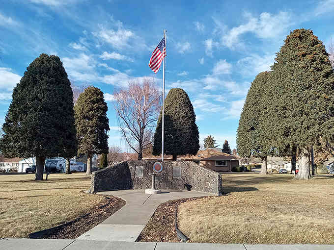 The town memorial stands dignified and proud, framed by evergreens that have witnessed generations of quiet American life.