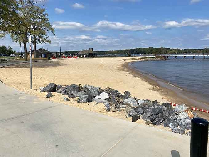 Smooth sand meets blue water under autumn skies, offering a peaceful lakeside retreat when you need it most.
