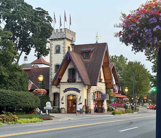 Hanging flower baskets burst with color against the Bavarian-style buildings, creating a scene worthy of any travel magazine cover.